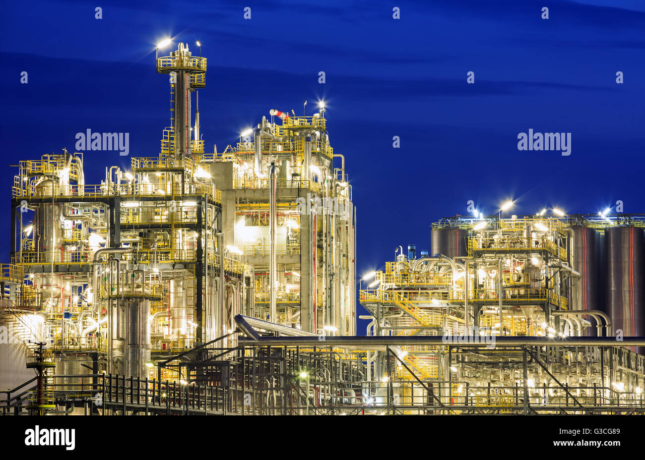 Oil refinery at night Stock Photo - Alamy