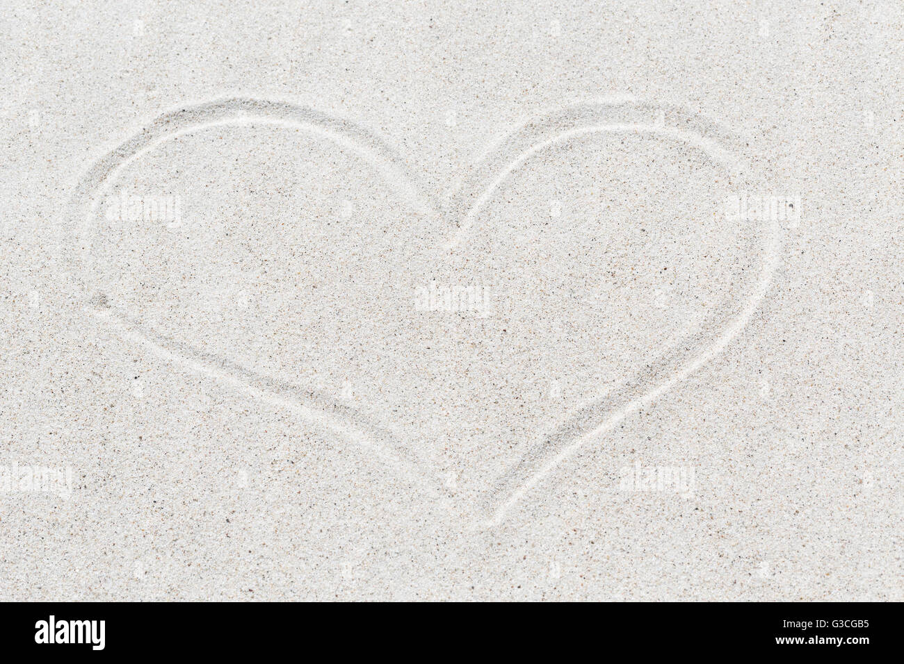 Heart shape on sand Stock Photo - Alamy