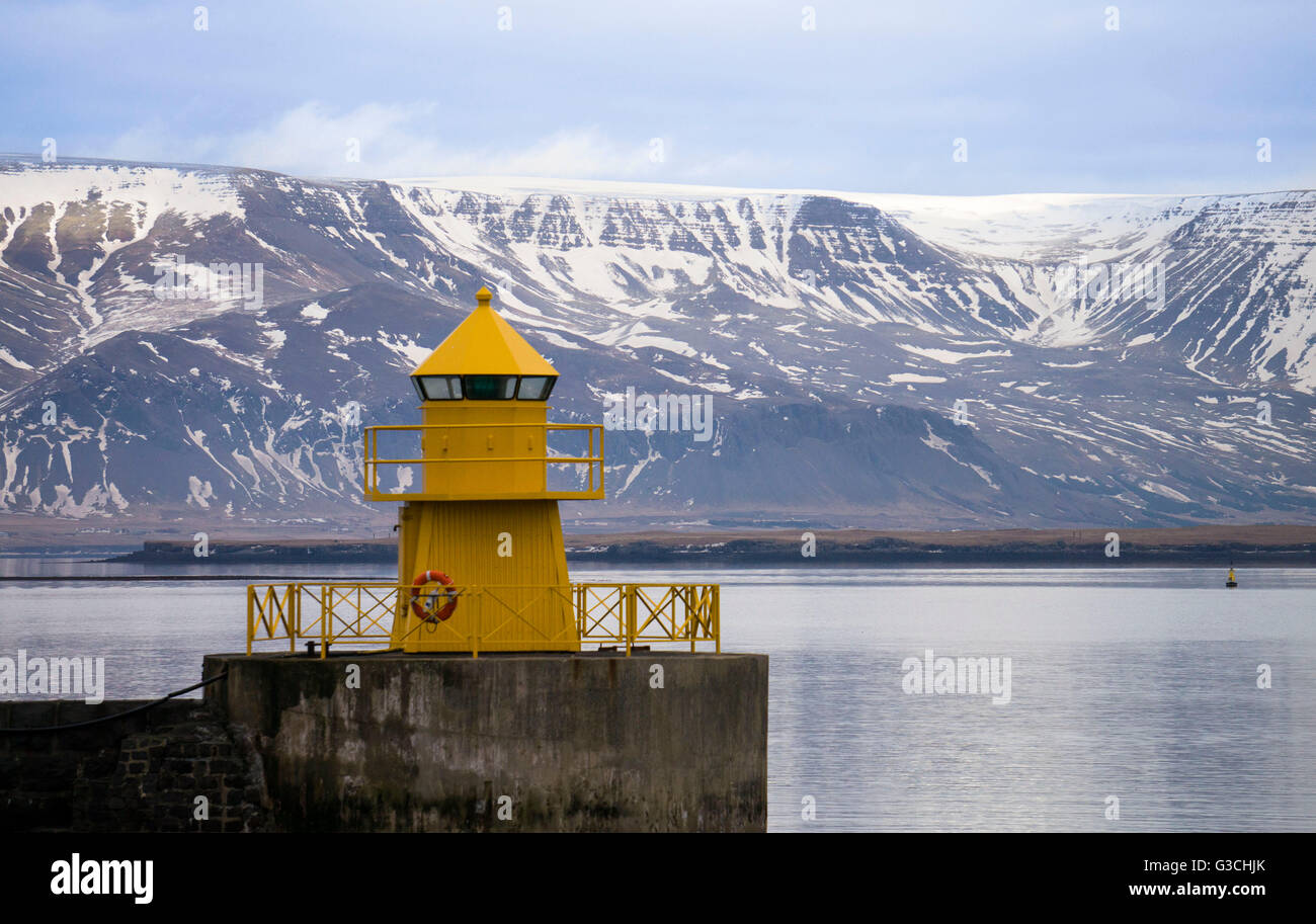 Yellow lighthouse in front of volcanoes, Reykjavik, Iceland Stock Photo ...