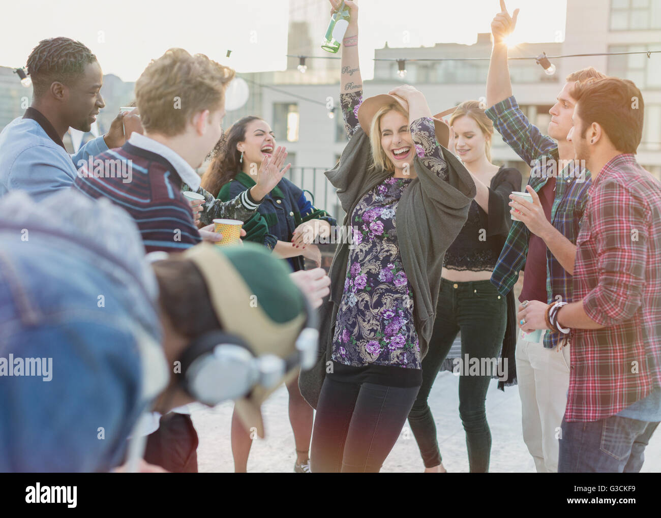 Playful young adult friends dancing at rooftop party Stock Photo - Alamy