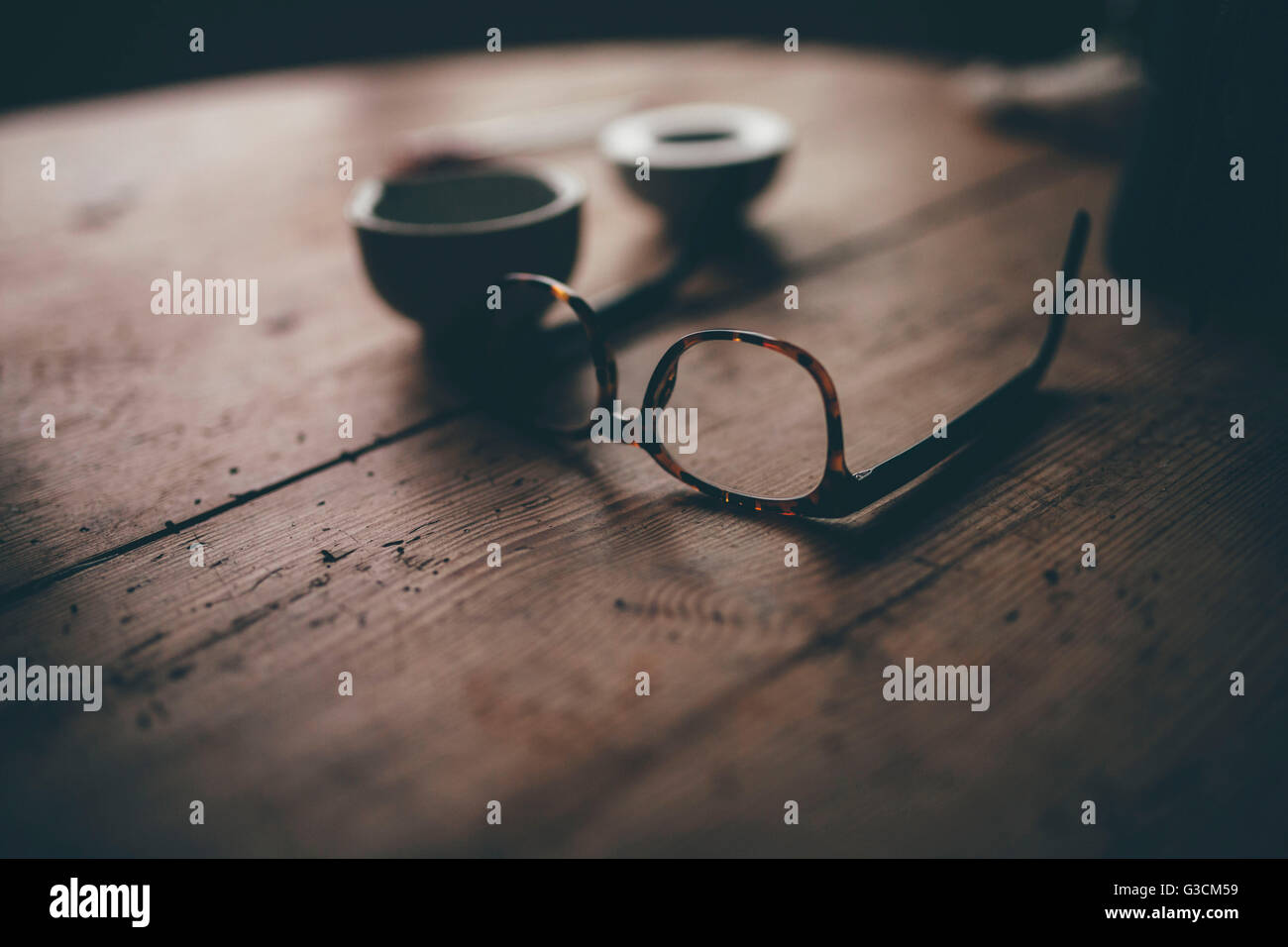 Glasses lying on table Stock Photo - Alamy