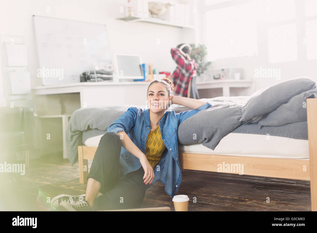 Female college student relaxing on bedroom floor Stock Photo - Alamy