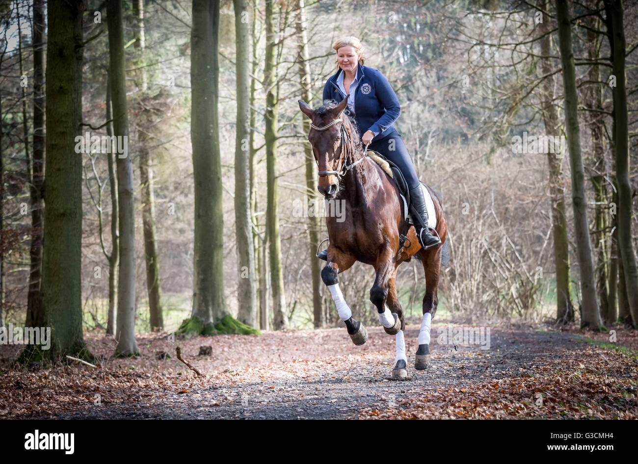 Woman riding horse through forest hi-res stock photography and images ...