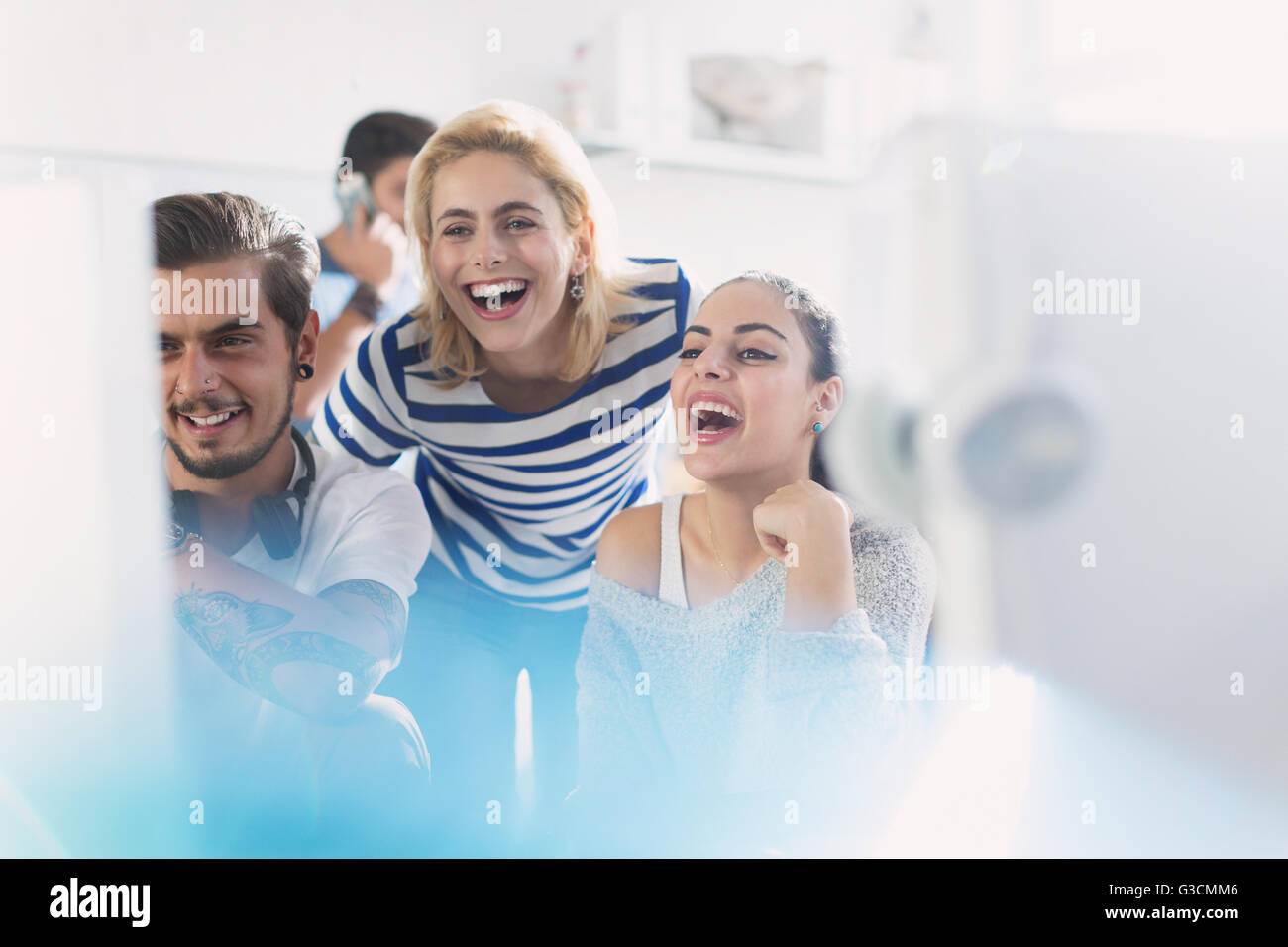 Creative business people laughing at computer in office Stock Photo - Alamy