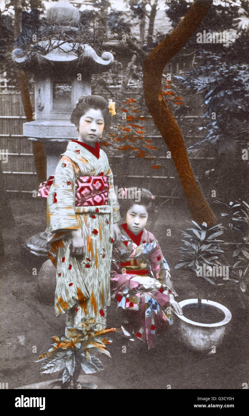 Japan - Two Geisha Girls - posing in an ornamental garden Stock Photo ...