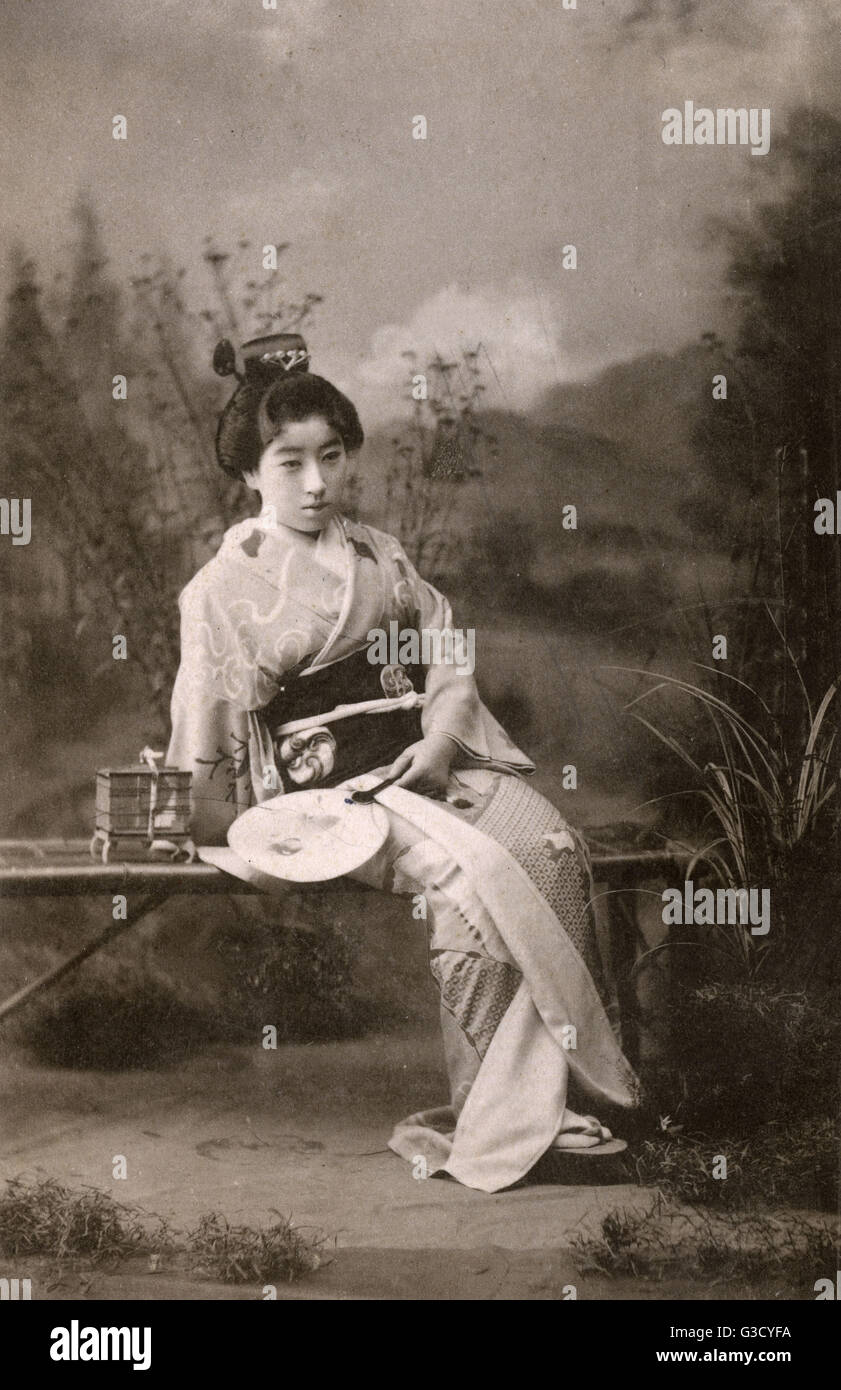 A Japanese Geisha posing in a studio garden setting Stock Photo - Alamy