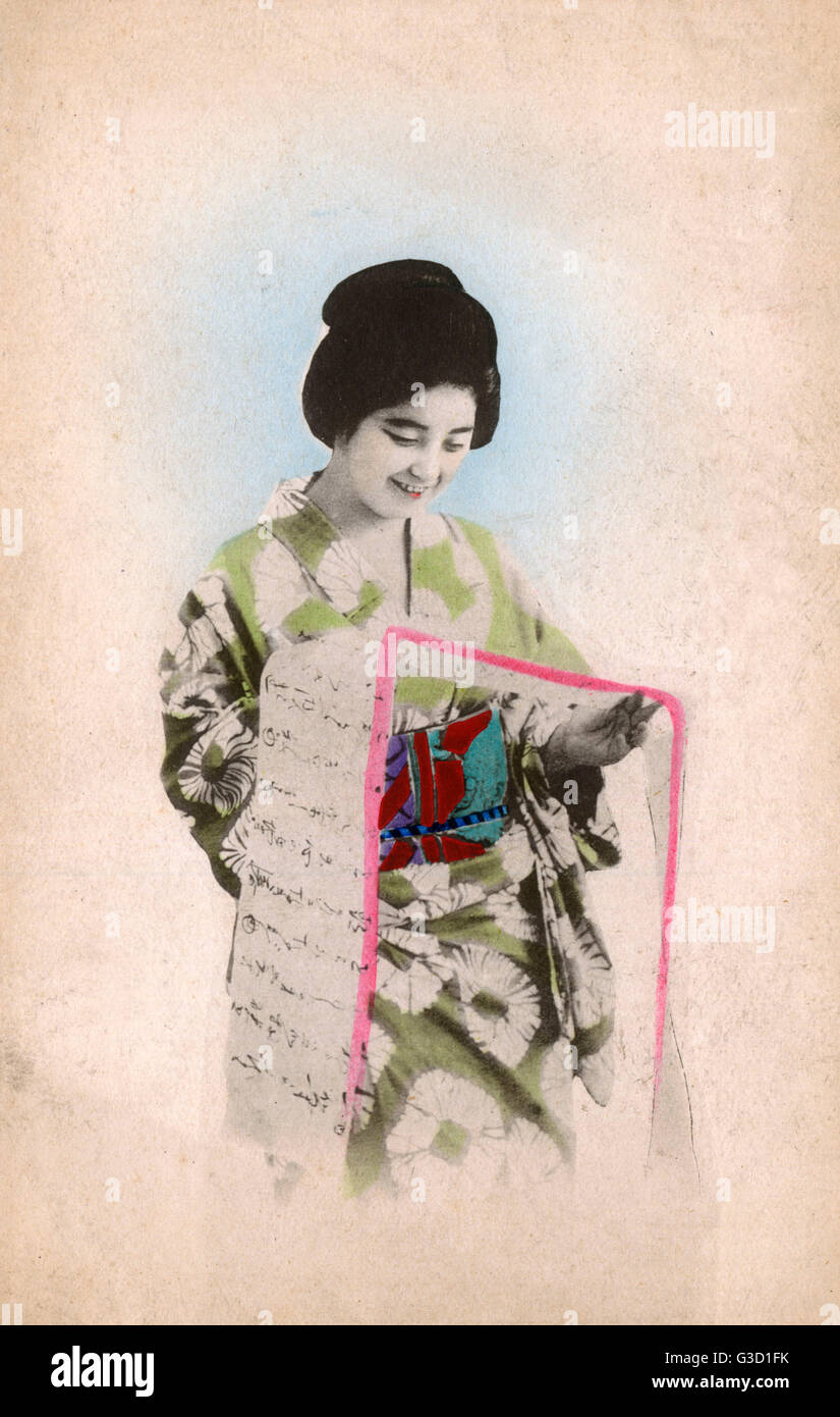 Japanese woman reading a long document and smiling Stock Photo - Alamy