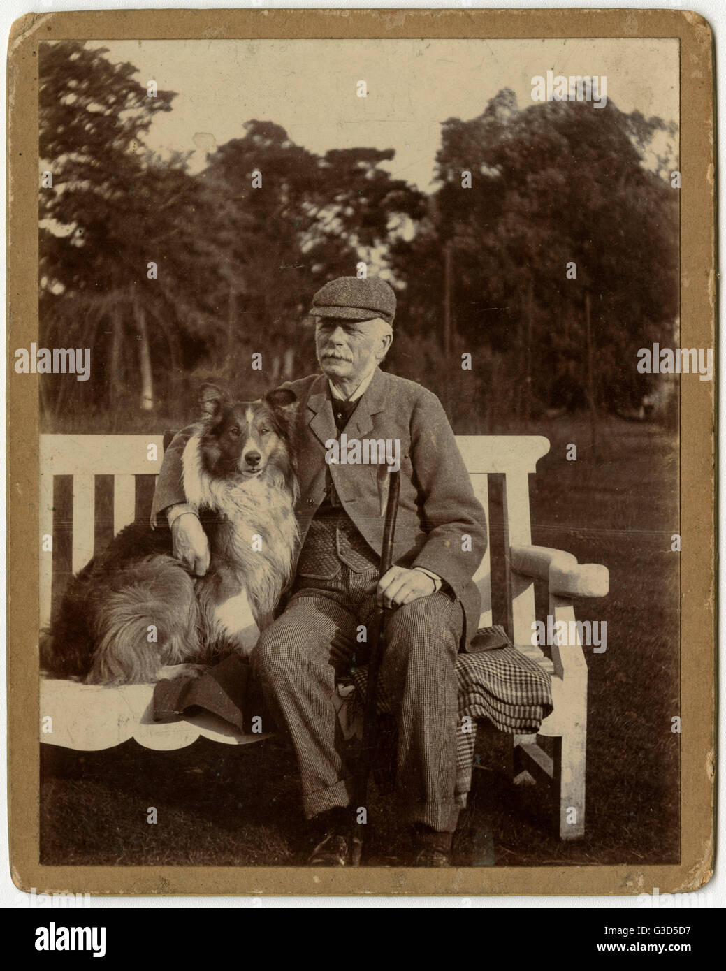 Man on a bench with his sheepdog Stock Photo - Alamy