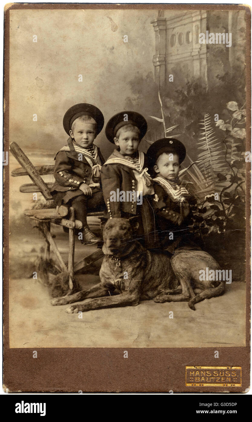 Studio portrait, three boys with dog Stock Photo - Alamy