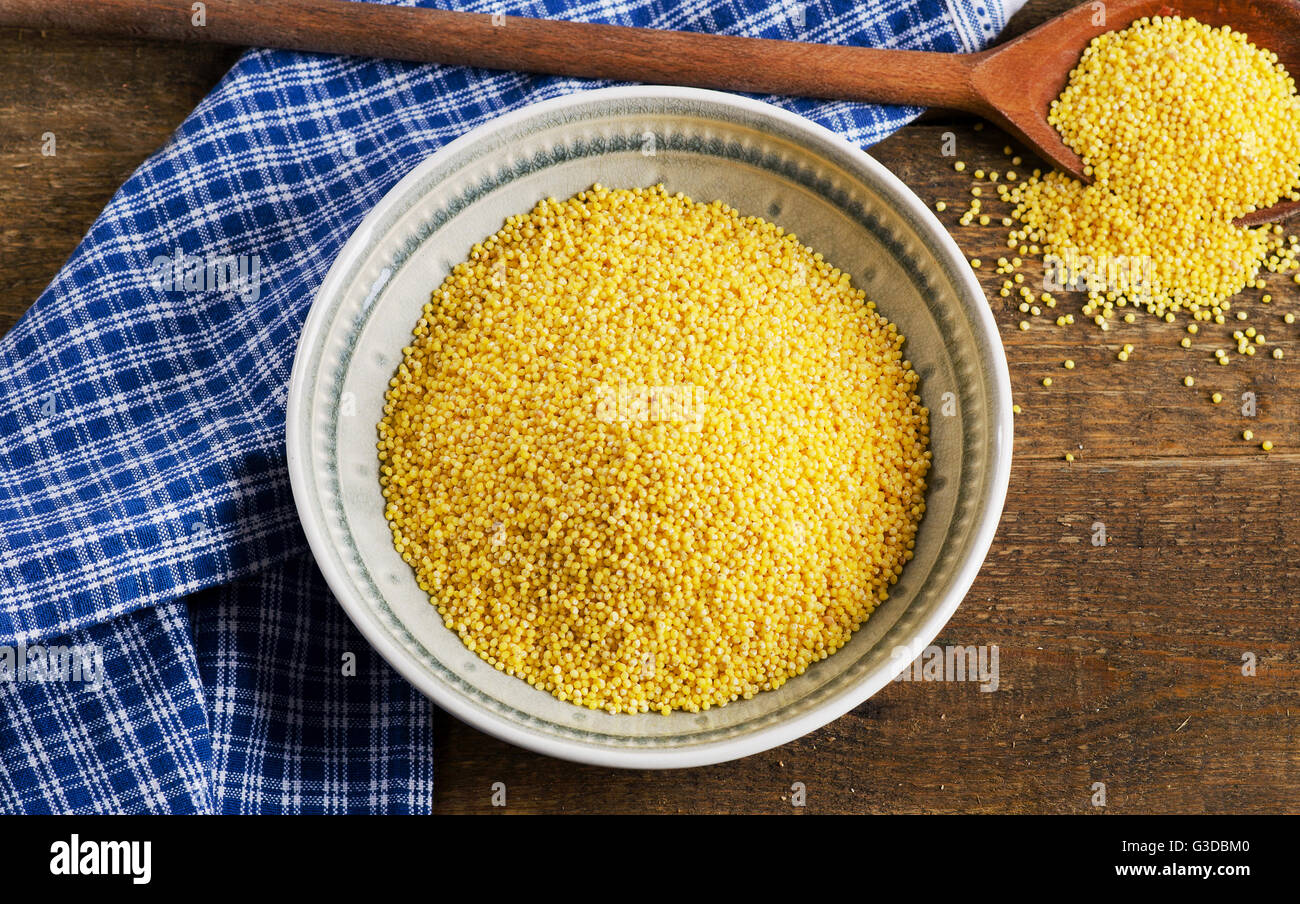 Raw Millet in bowl. Top view Stock Photo - Alamy