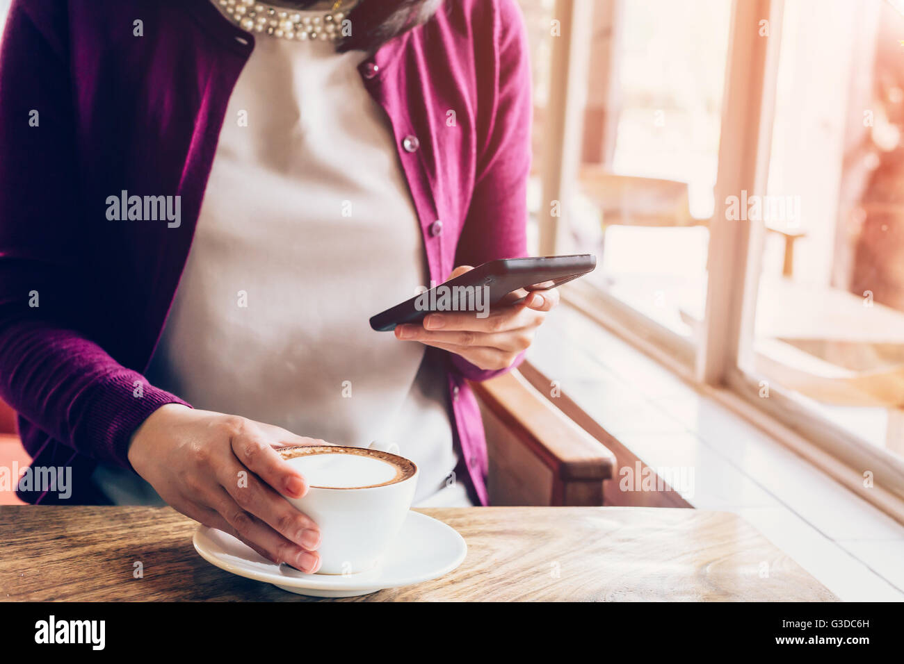woman using smartphone in coffee shop with vintage tone Stock Photo - Alamy
