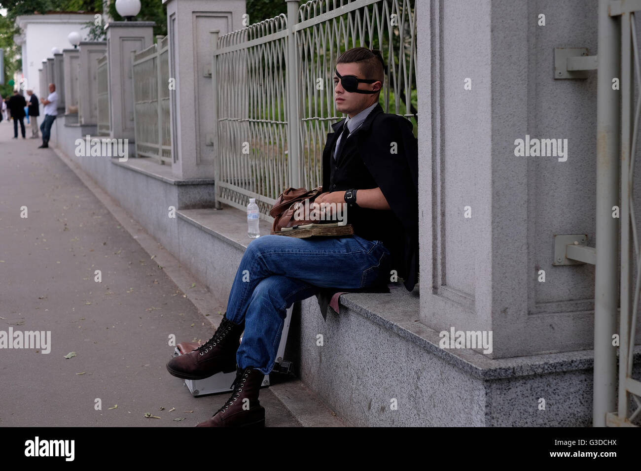 A Ukrainian student wearing an eye patch sits at the entrance to the ...
