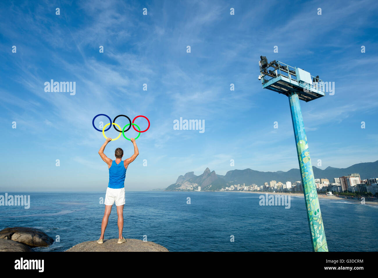 RIO DE JANEIRO - MARCH 27, 2016: Athlete holds Olympic rings standing ...