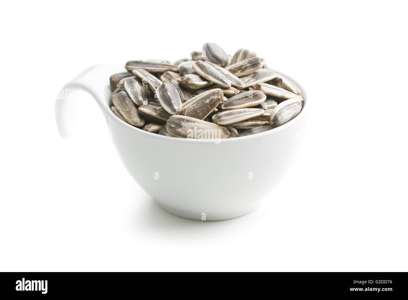 Unpeeled sunflower seeds in bowl isolated on white background Stock ...