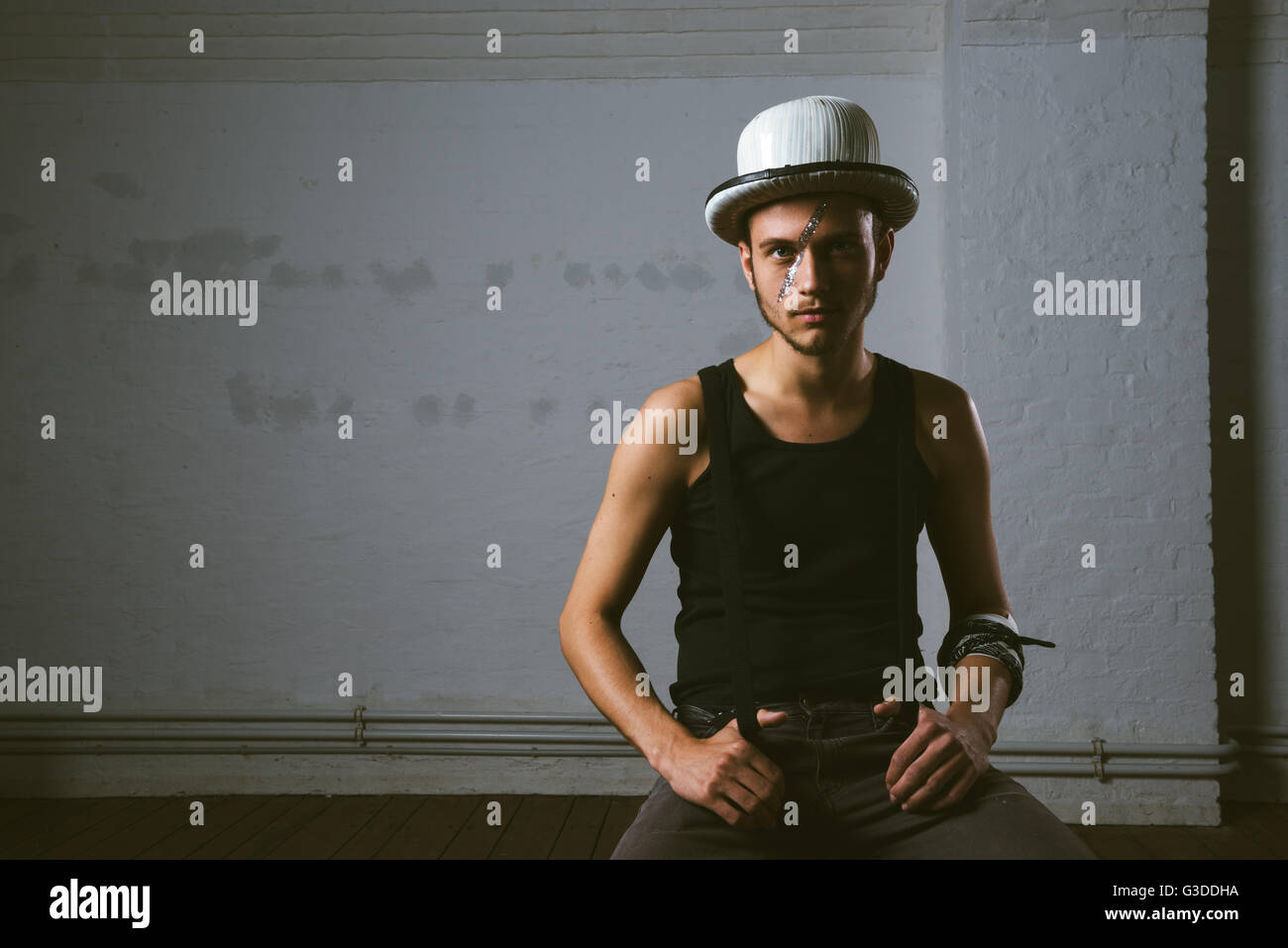 Male fashion model with hat made of drum parts Stock Photo - Alamy
