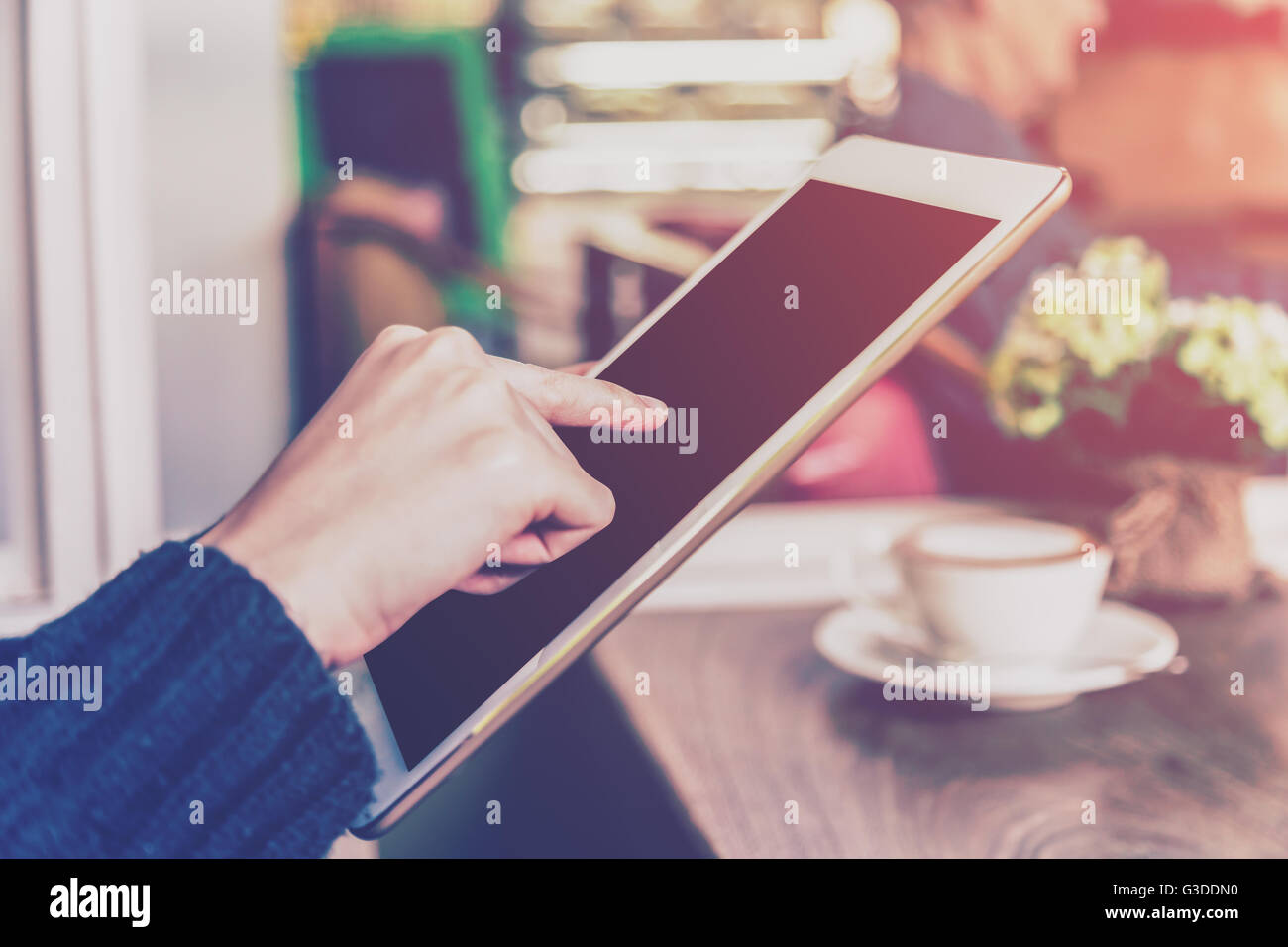 Asian woman using tablet computer in coffee shop with Vintage tone ...