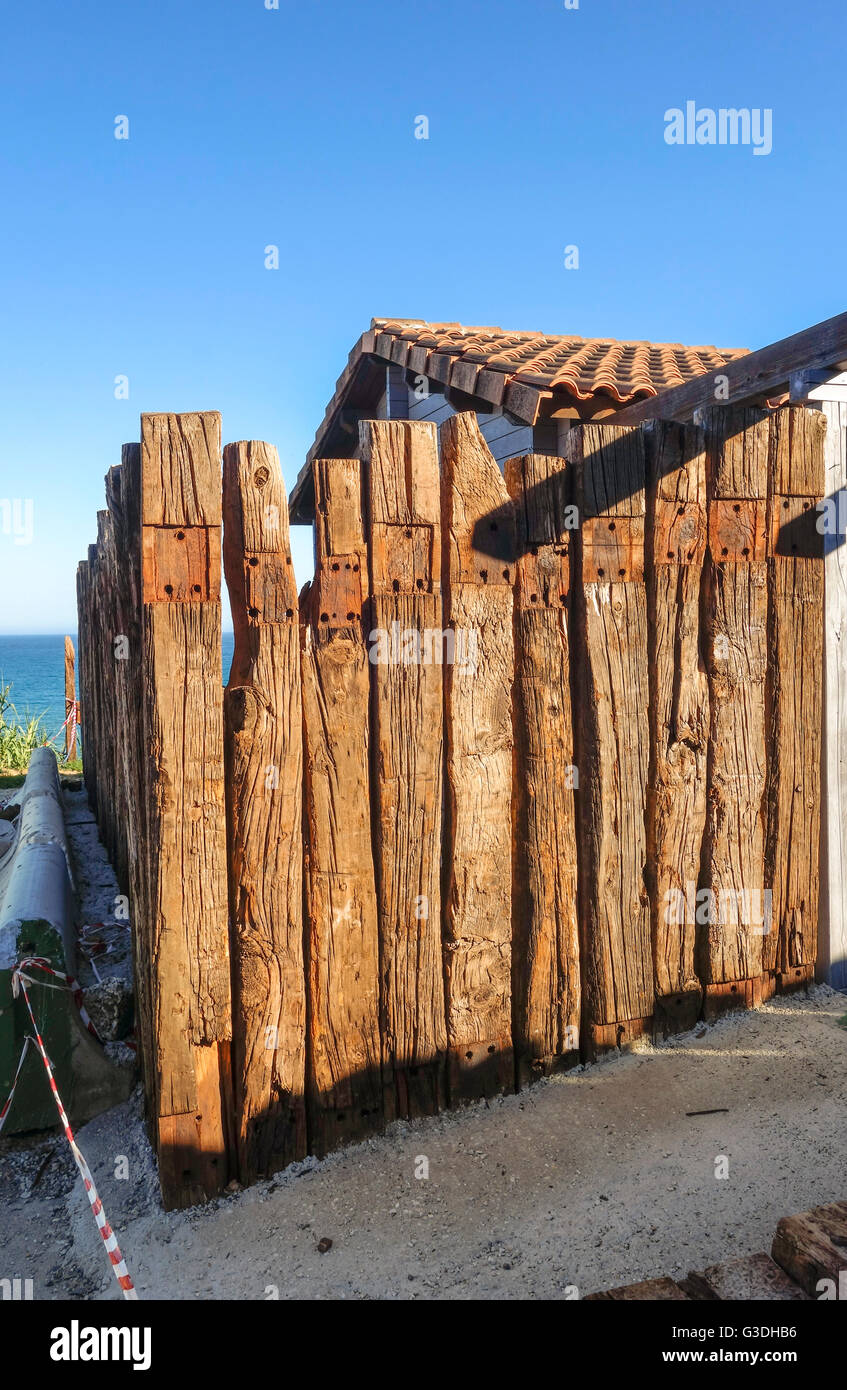Fence around wooden house made of Railway Sleepers, logs, Spain Stock ...