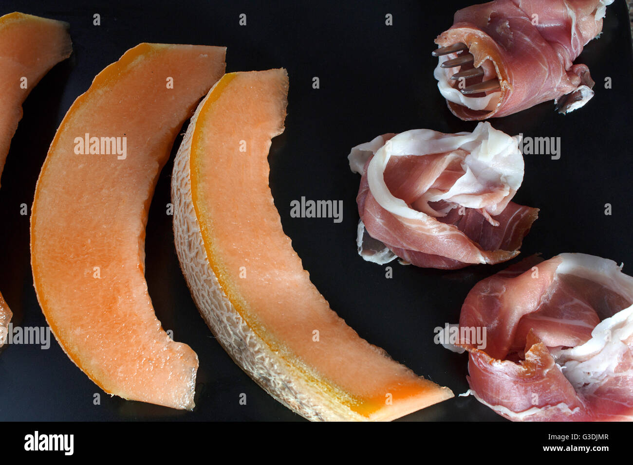 Slices of fresh melon with roses of Parma Italian ham, as typical ...