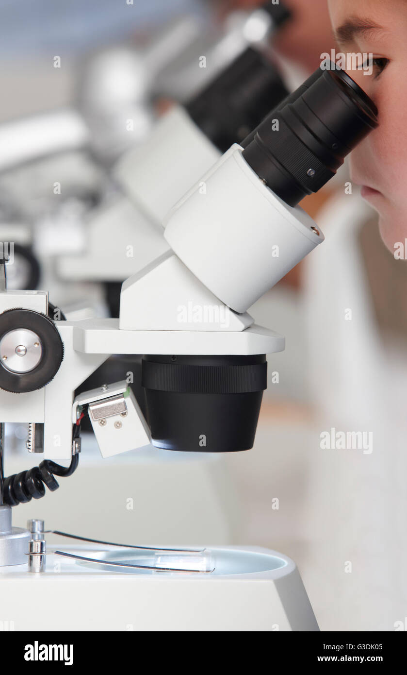 Student and microscope in the science laboratory. Vertical format Stock ...