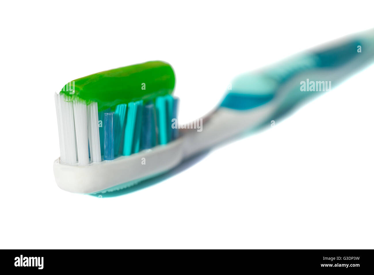 Blue toothbrush with green toothpaste isolated on a white background ...