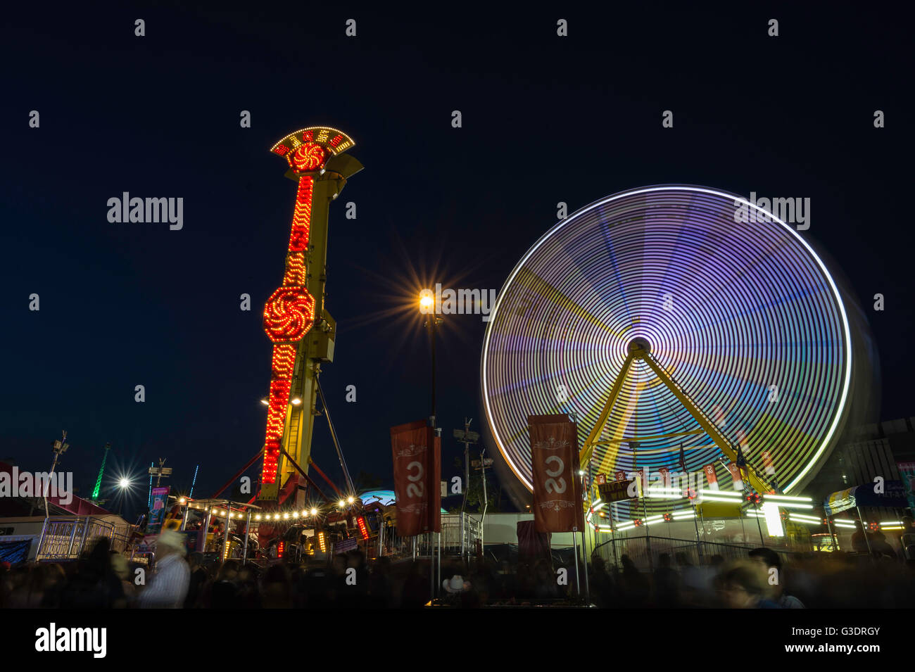 Ferris wheel and other rides at night, Calgary Stampede Midway, Calgary ...