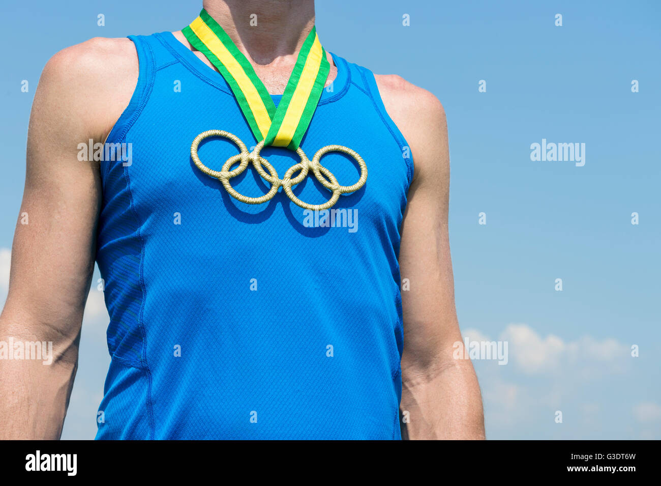 RIO DE JANEIRO - MARCH 20, 2016: Athlete stands wearing Olympic rings ...