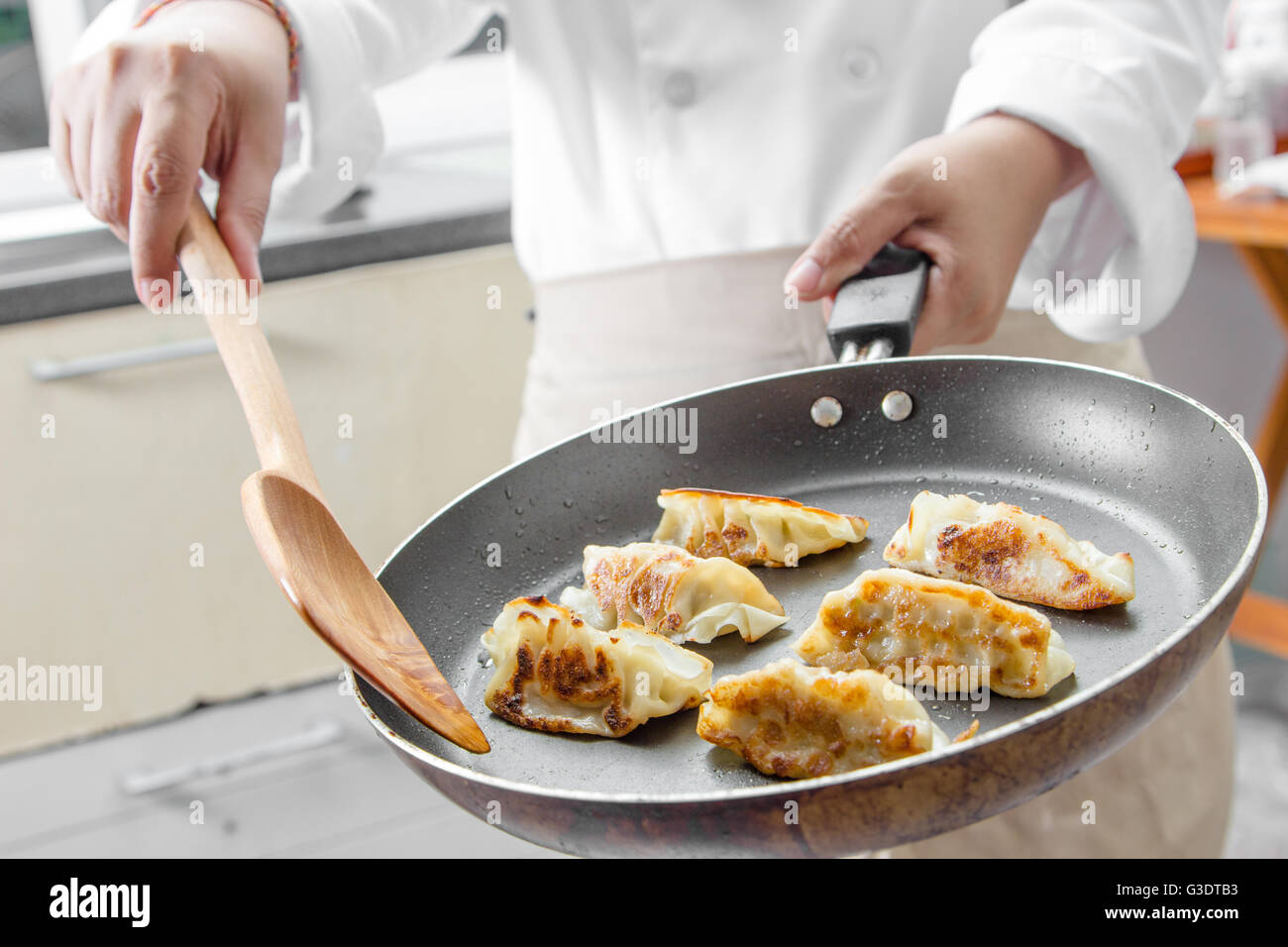 chef making Gyoza (Japanese Dumplings) in frying pan Stock Photo - Alamy