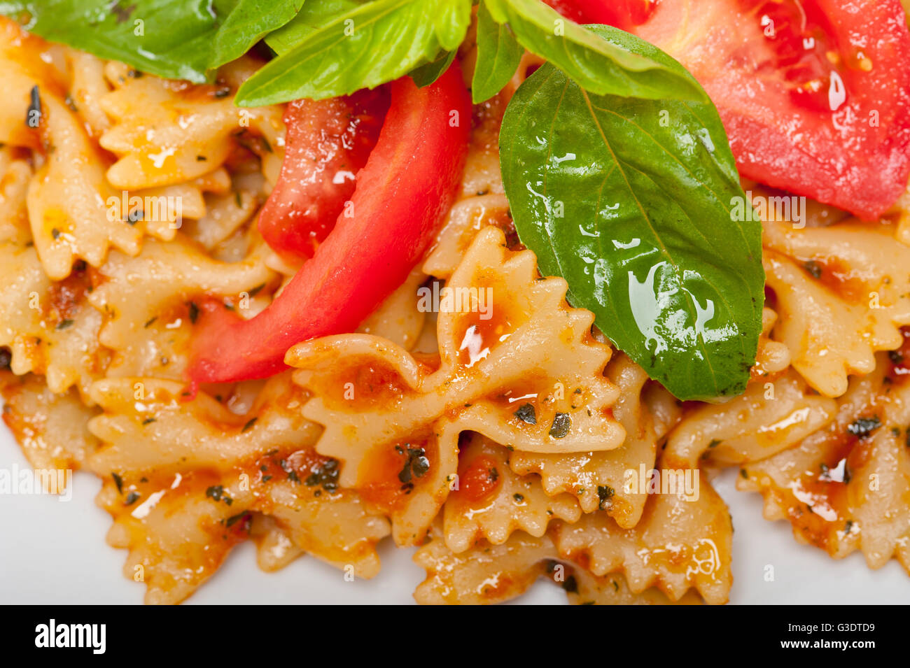 Italian pasta farfalle butterfly bow-tie with tomato basil sauce over ...