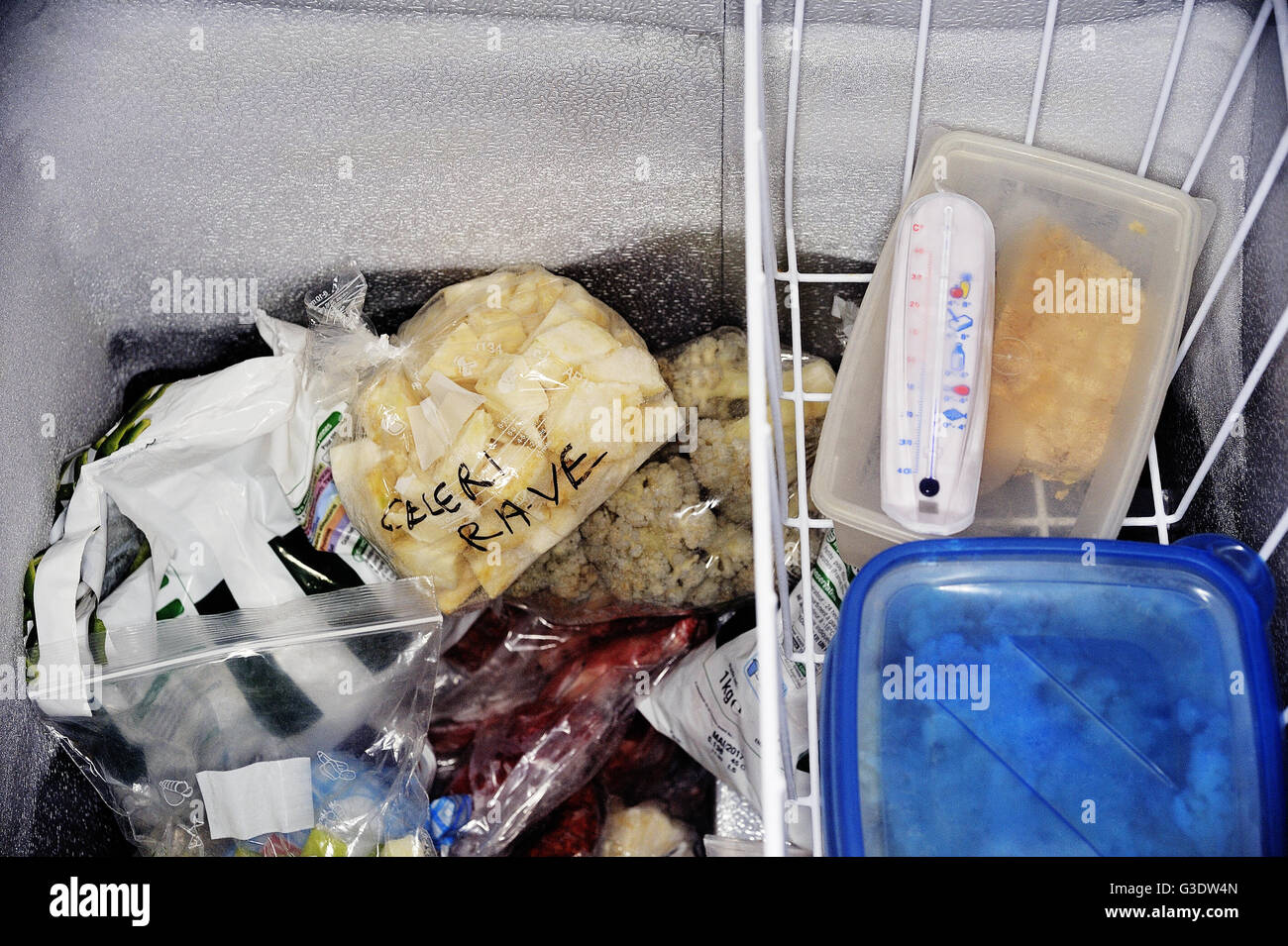 Freezer opened with thermometer for temperature control Stock Photo - Alamy