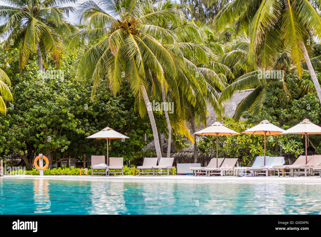 Luxury beach resort, bungalow near endless pool over sea sunset ...
