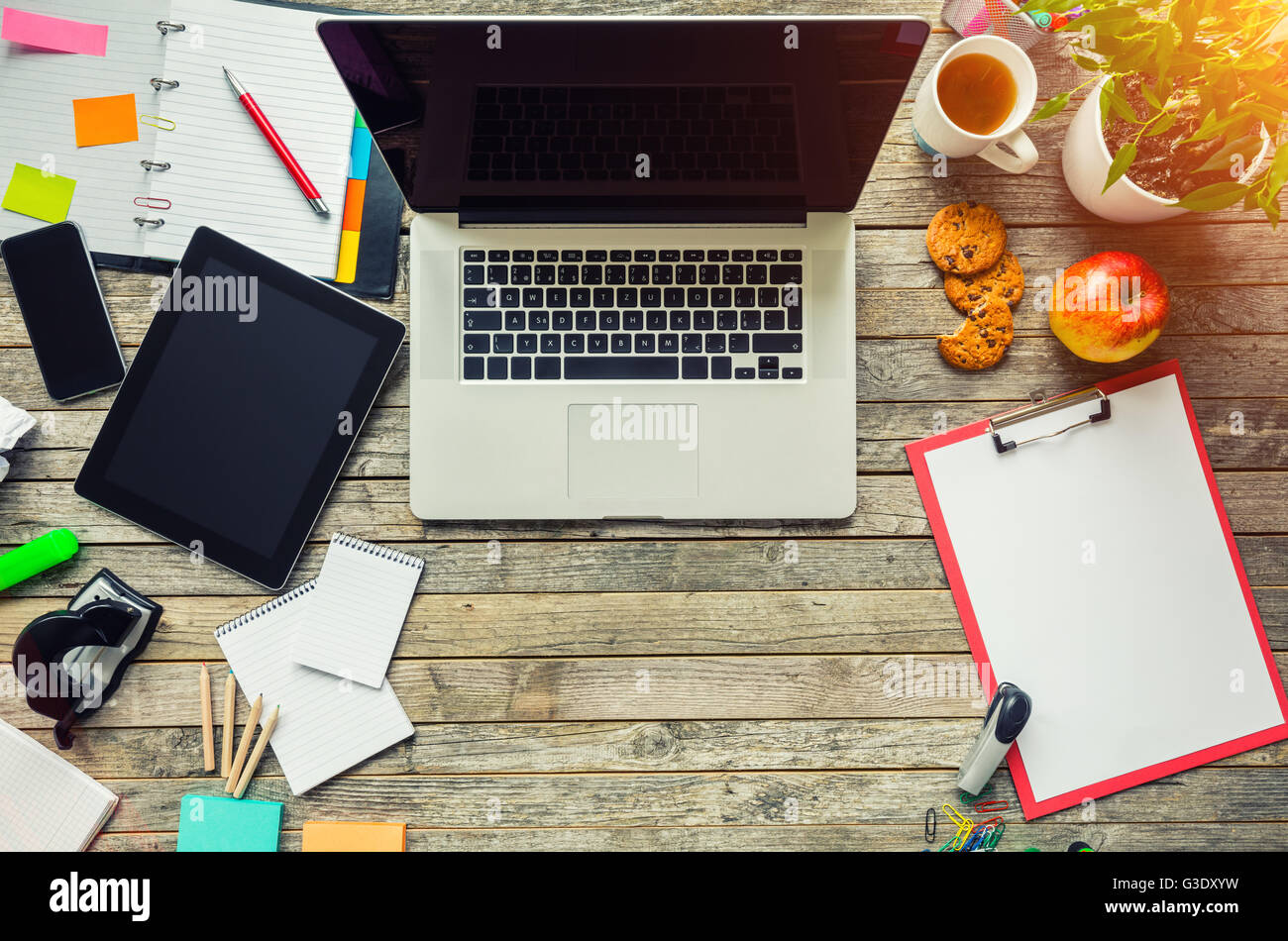 Aerial view of laptop with other modern electonic devices on desk ...