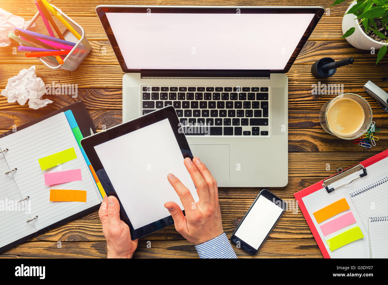 Close-up of businessman hands working on modern electronic devices ...