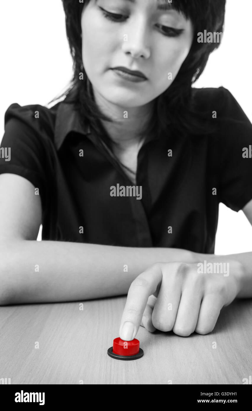 Studio shot of a thoughtful model holding her finger poised above a red ...
