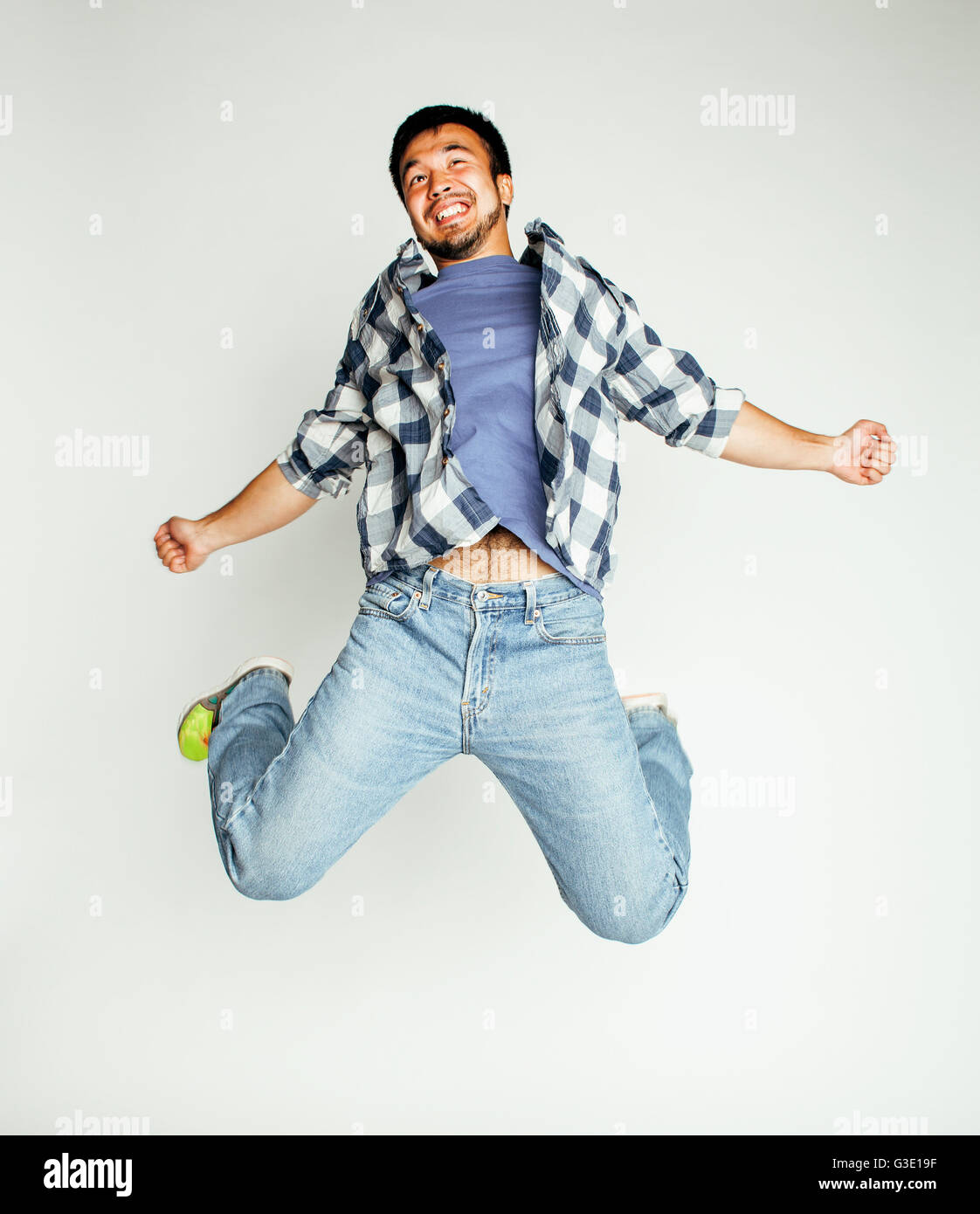 young pretty asian man jumping cheerful against white background ...