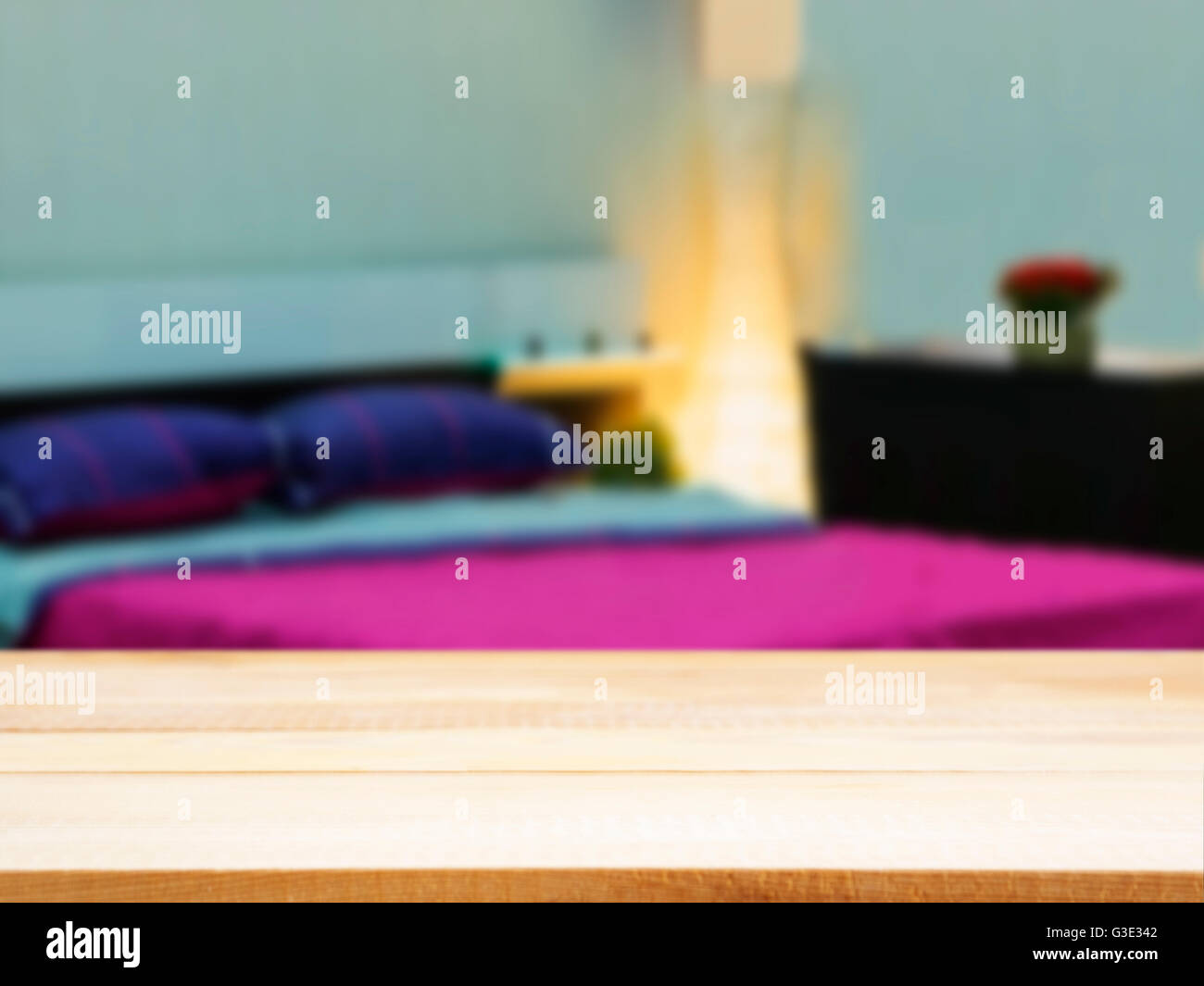 Wooden empty table in front of blurred bedroom Stock Photo - Alamy