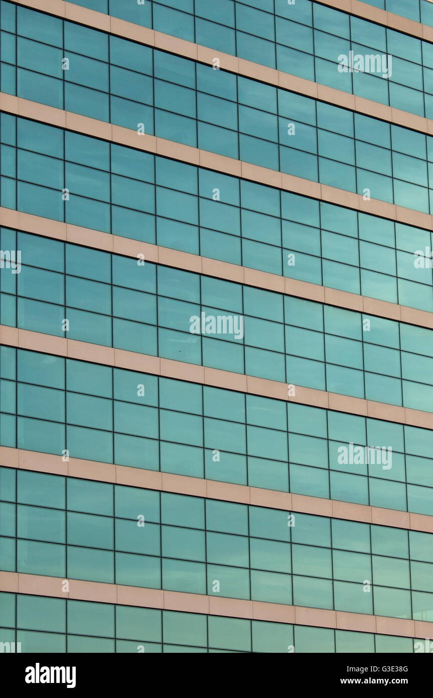 Modern glass skyscraper reflecting a blue sky background Stock Photo ...