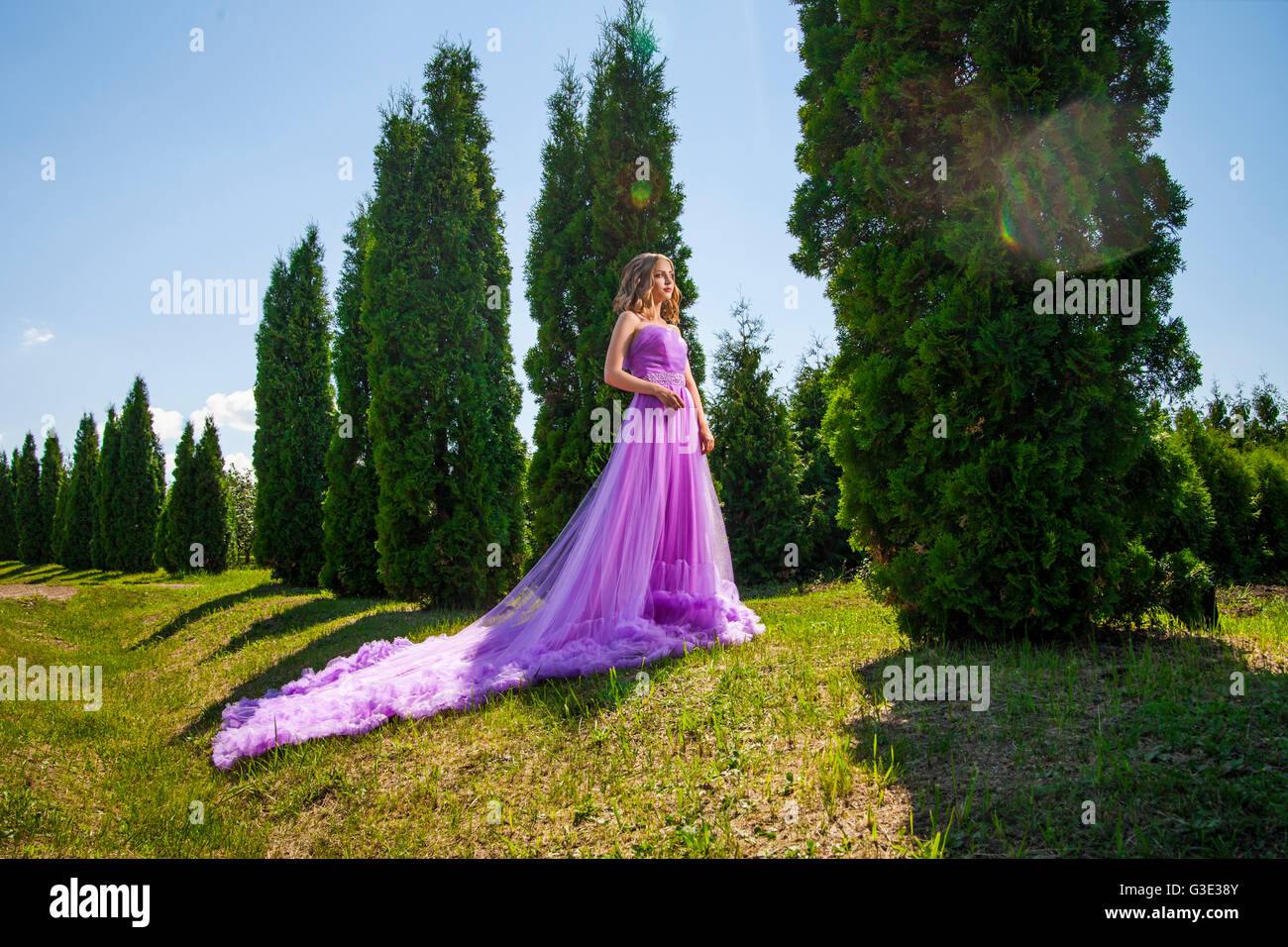 Young woman in beautiful dress amongst trees Stock Photo - Alamy