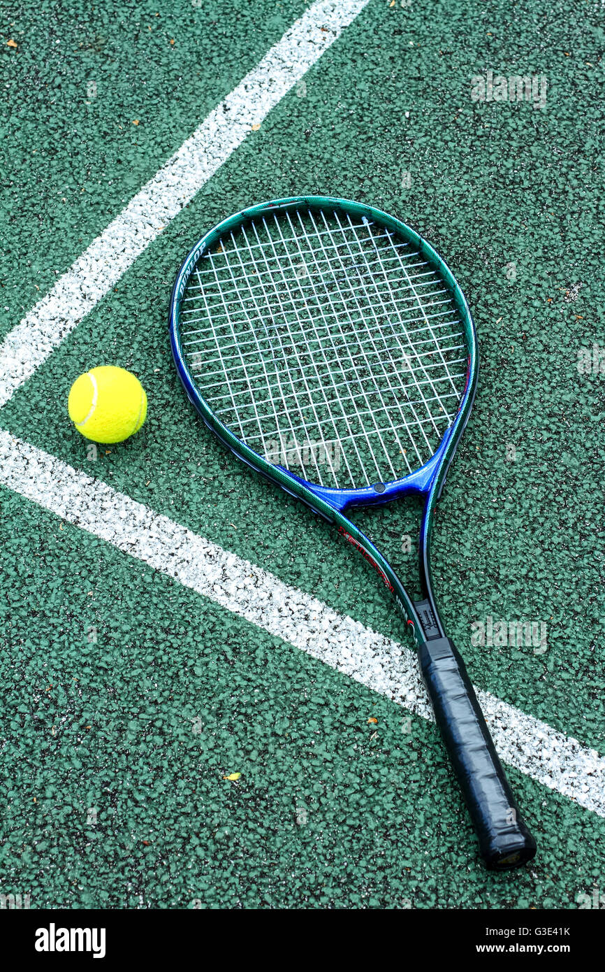 Tennis racket and tennis ball on a hard tennis court Stock Photo - Alamy