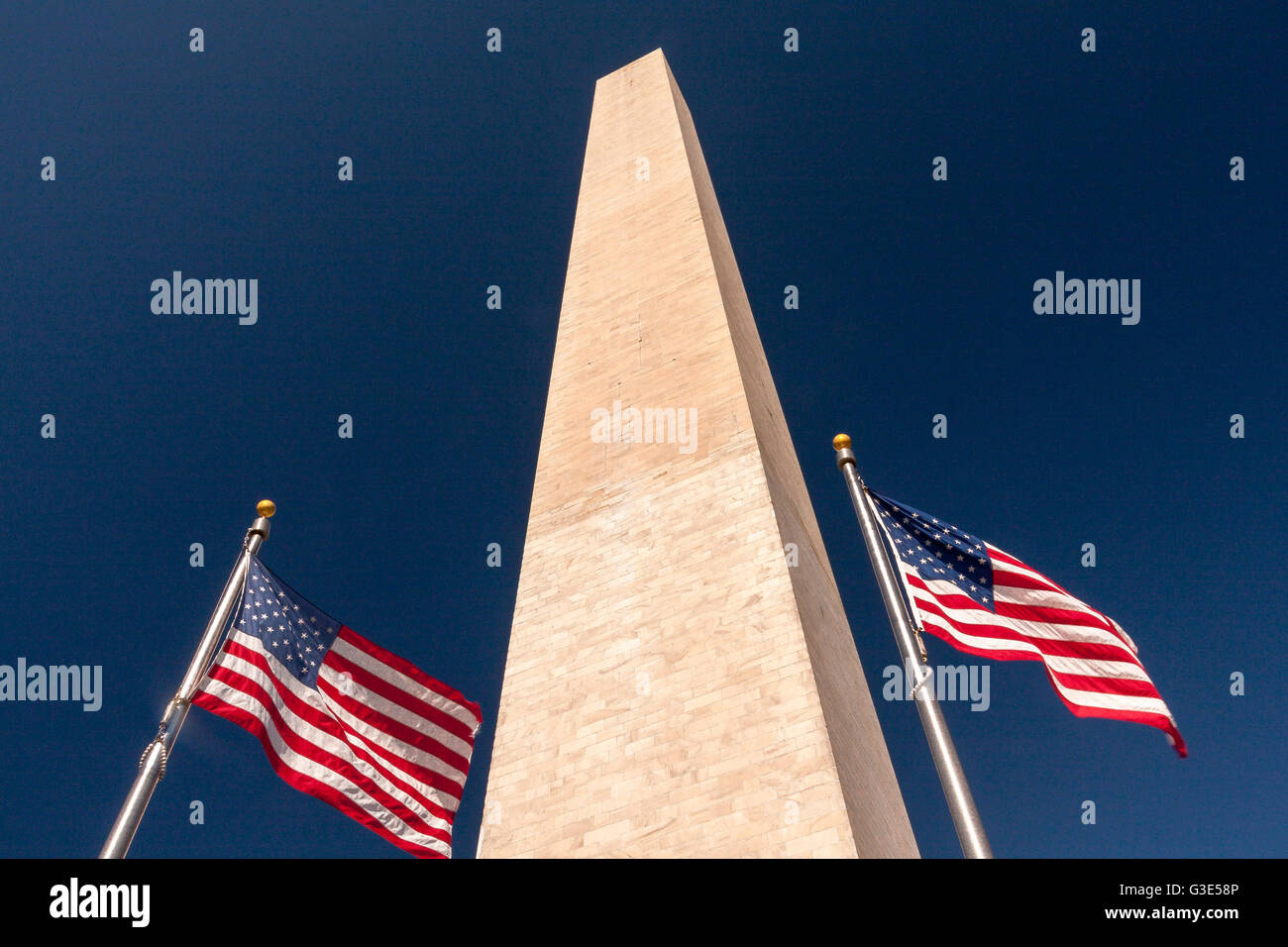 American flags at the Washington Monument, a tall obelisk within the ...