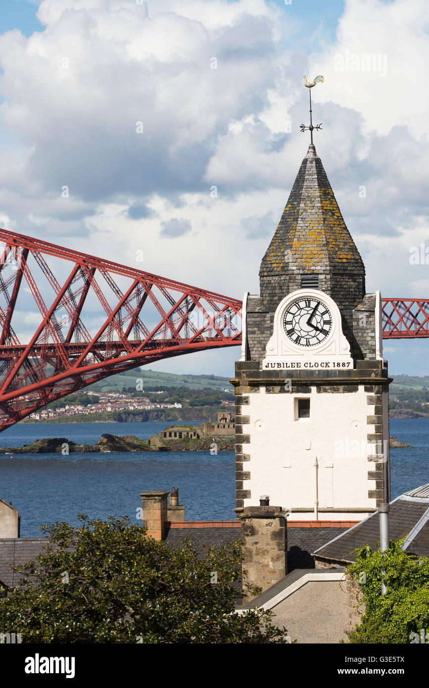 Clock tower and red metal bridge at the waterfront; Edinburgh, Scotland ...