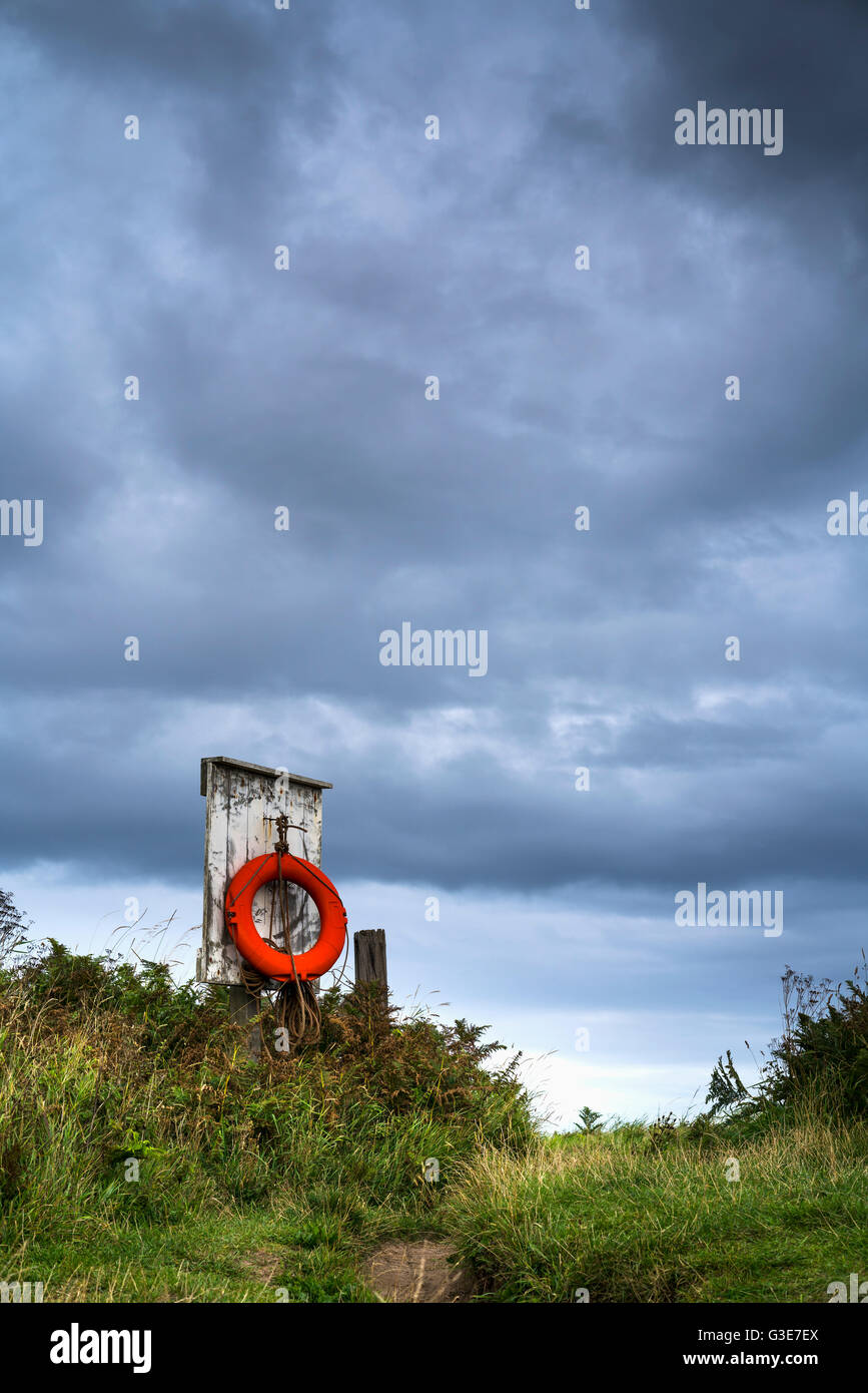 Red ring life preserver hanging on a wooden post; Northumberland ...