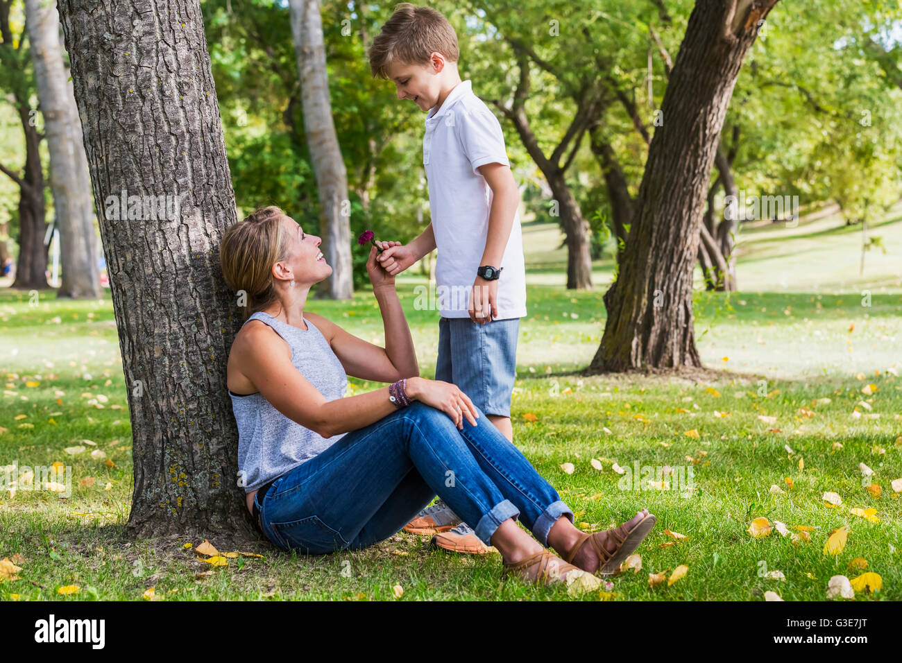 Mother getting a flower from her son while spending quality time at a ...