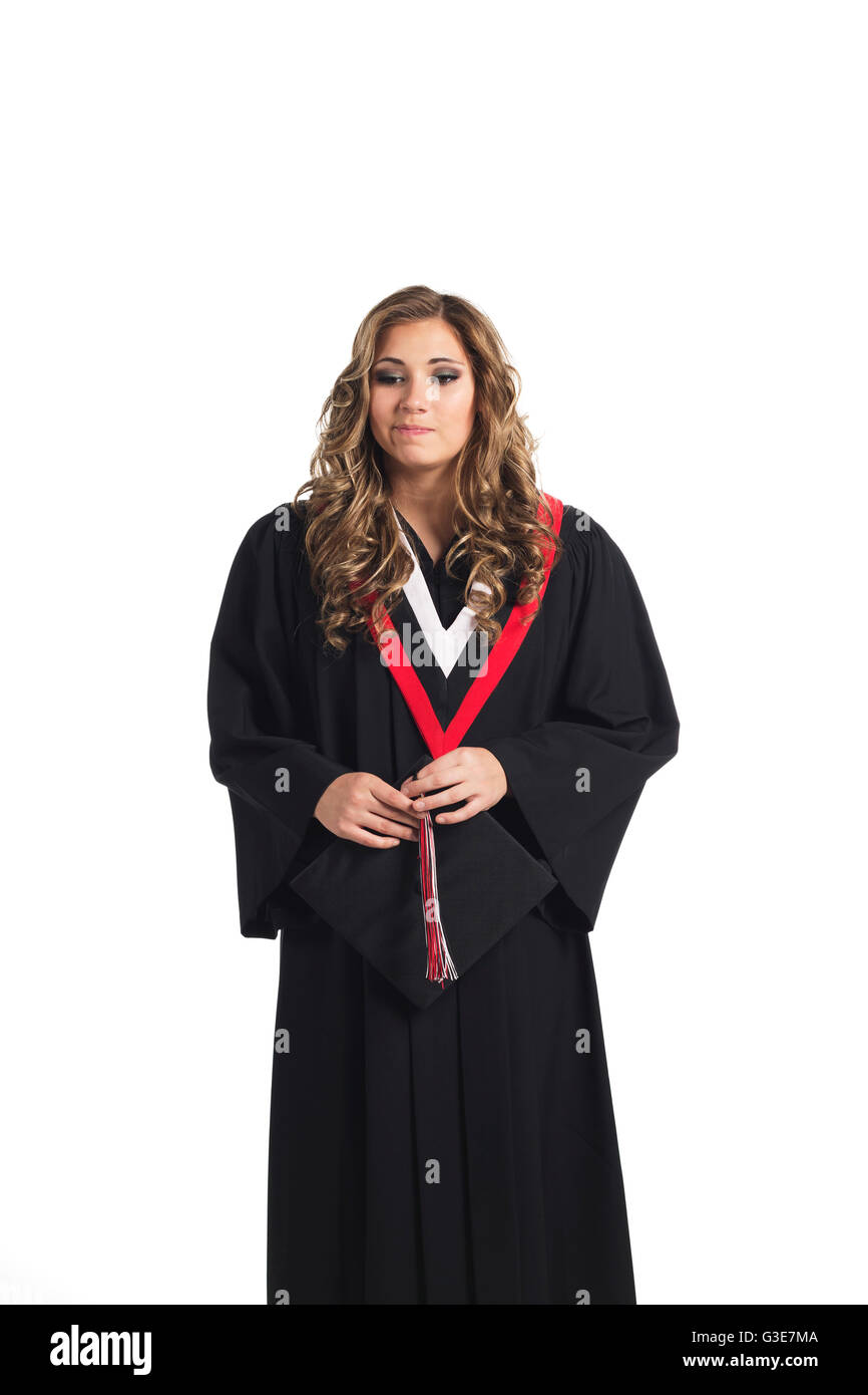 Young graduating woman holding her graduation cap and contemplating her ...