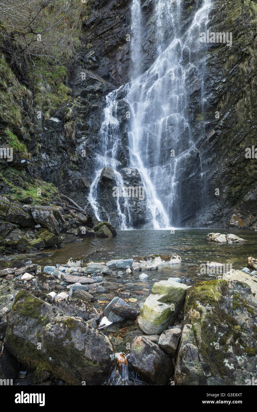 Waterfall cascades into a Scottish burn strewn with boulders, Western ...