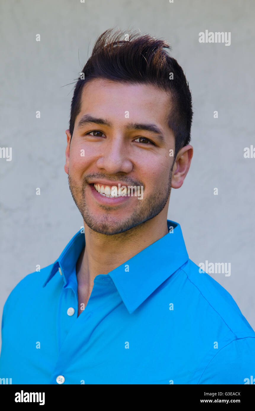 Portrait of smiling Hispanic man in blue. Headshot vertical Stock Photo ...