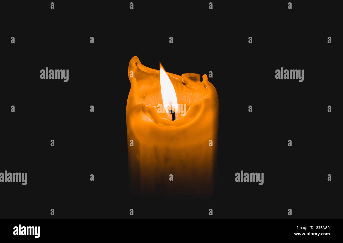 One light candle burning brightly with black background Stock Photo - Alamy