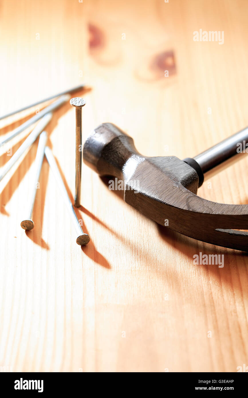 Nails set near hammer on nice wooden background Stock Photo - Alamy