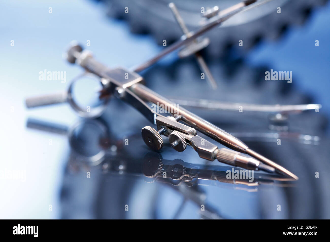 Engineering concept. Divider on glass surface against gray background ...