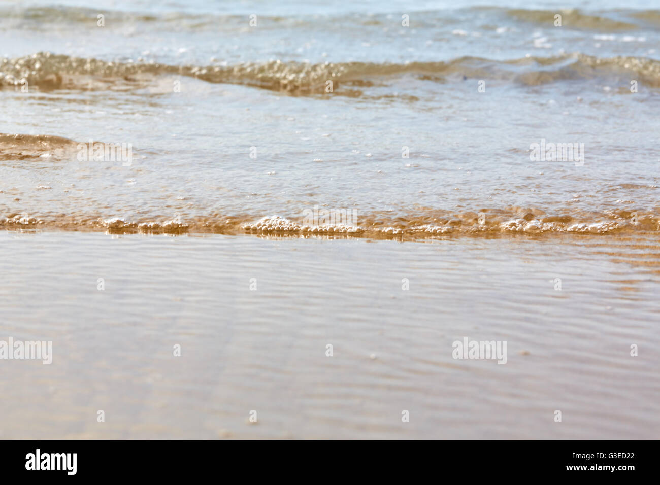 Little ripples in the sand from the sea on the beach Stock Photo - Alamy