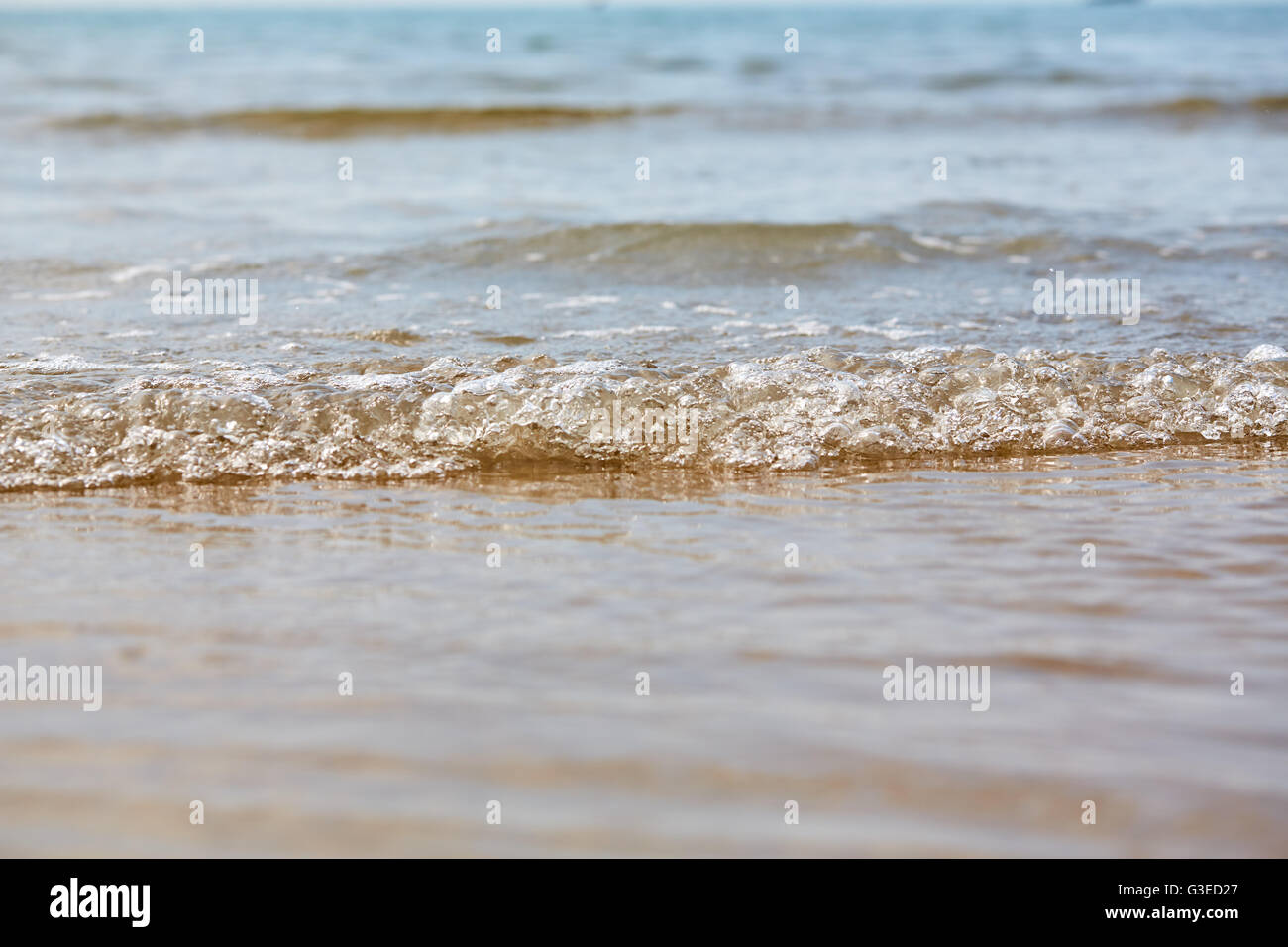 Little ripples in the sand from the sea on the beach Stock Photo - Alamy